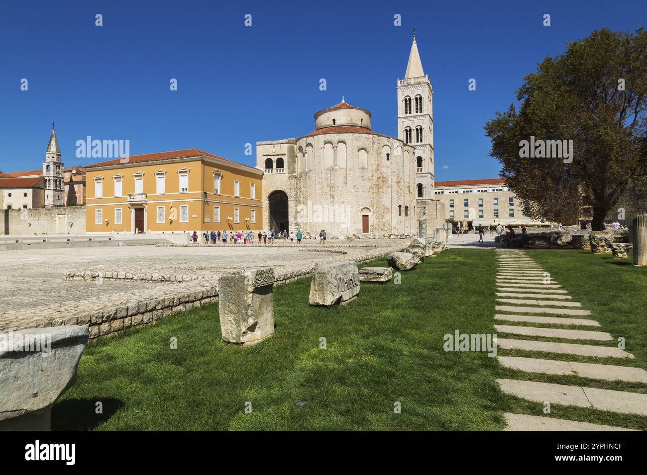Architectural remnants on display at Roman forum ruins with the church ...