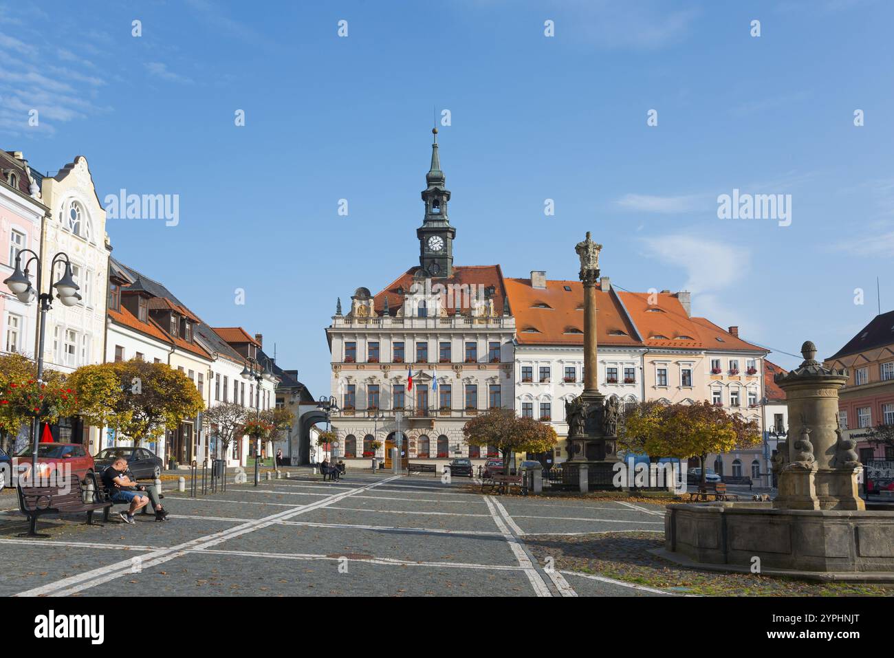 Historic town square with Baroque-style buildings and clock tower under ...