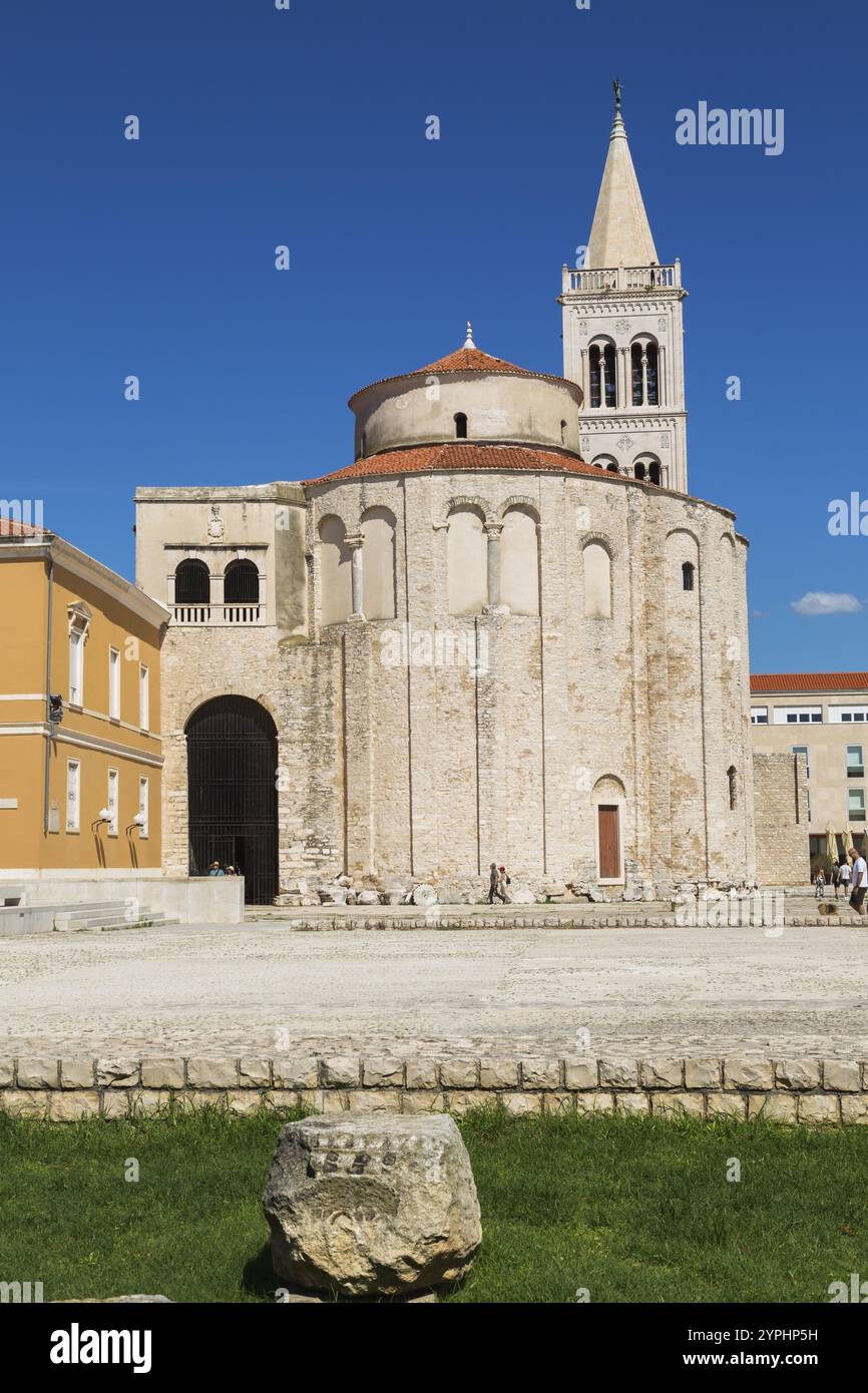 Architectural remnant on display at Roman forum ruins with the church ...