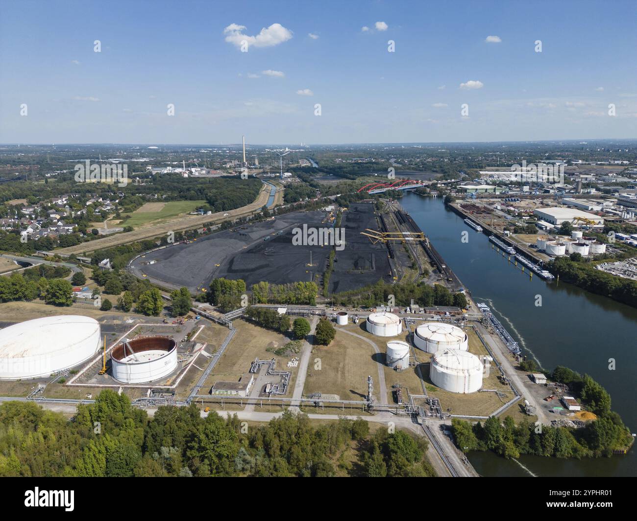 Aerial view of a port with coal storage, fuel depots and of oil tanks ...