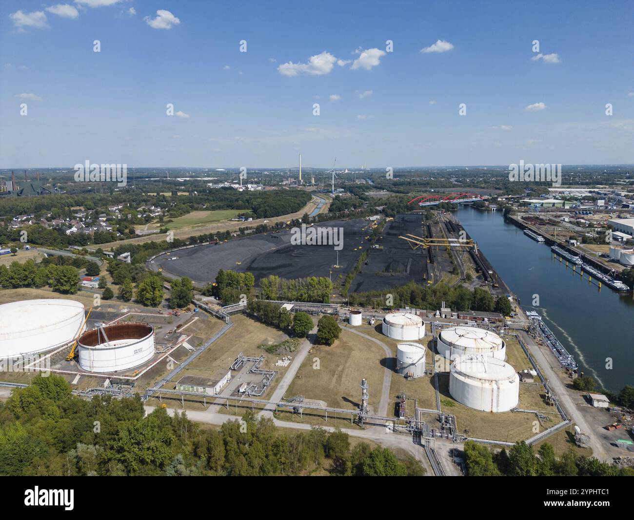 Aerial view of a port with coal storage, fuel depots and of oil tanks ...