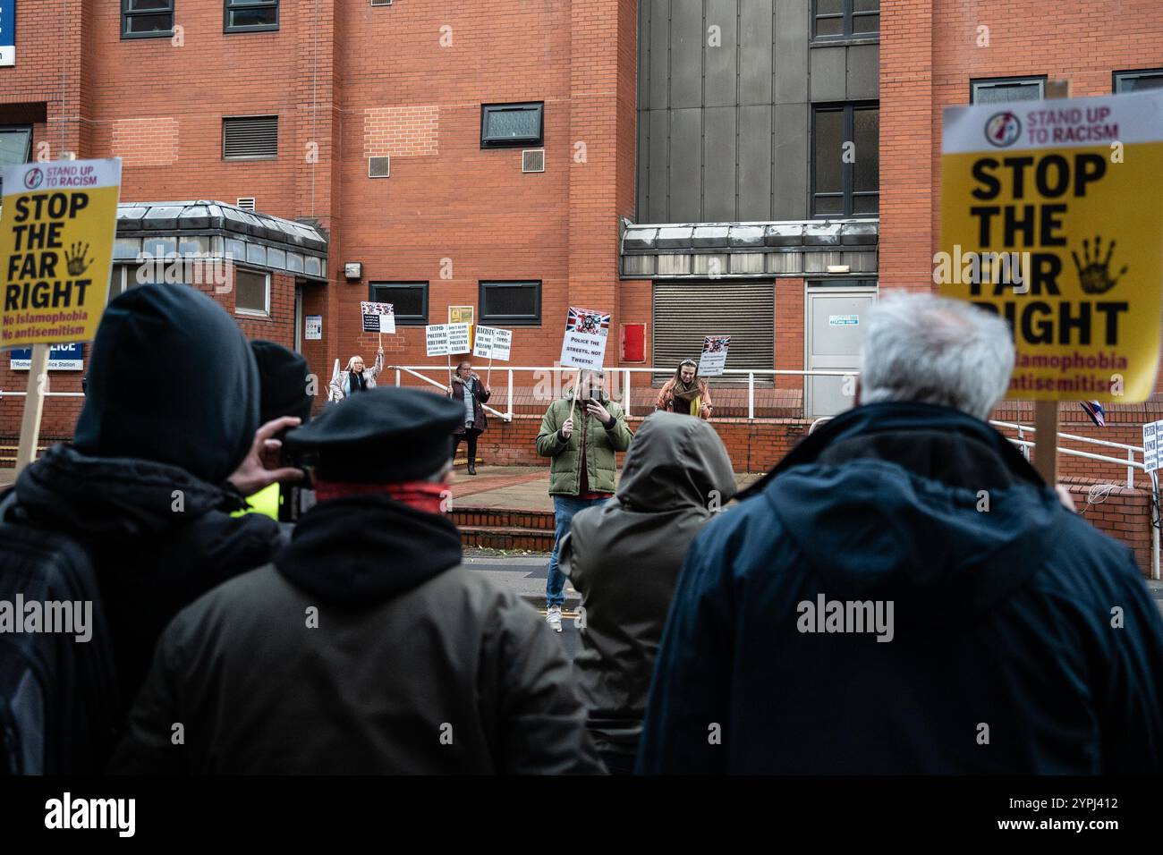Protesters hold placards expressing their opinion during the rally. A ...