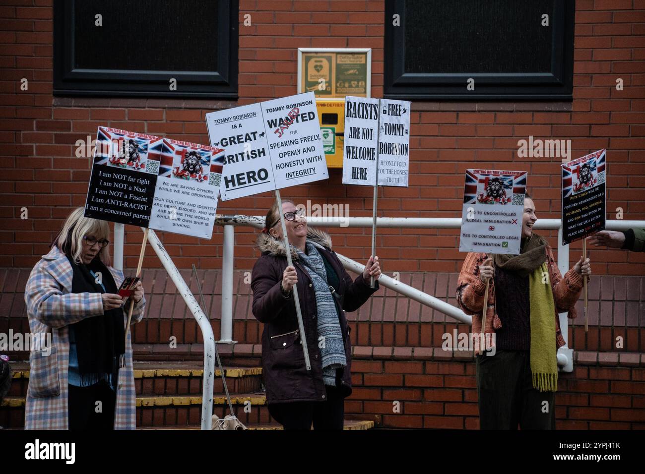Rotherham, UK. 30th Nov, 2024. Protesters hold placards expressing ...
