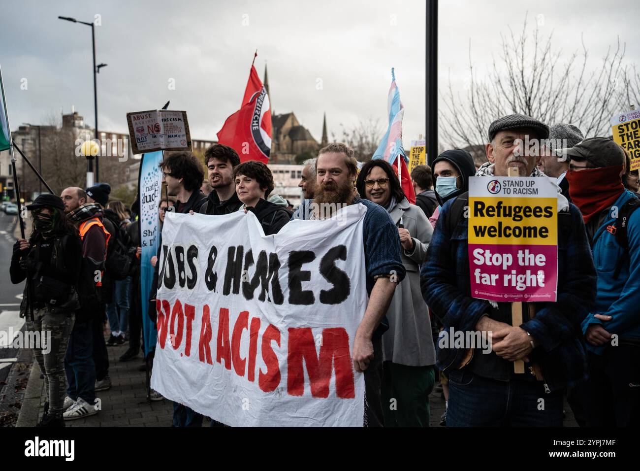 Rotherham, UK. 30th Nov, 2024. A group of counter-protestors hold a ...