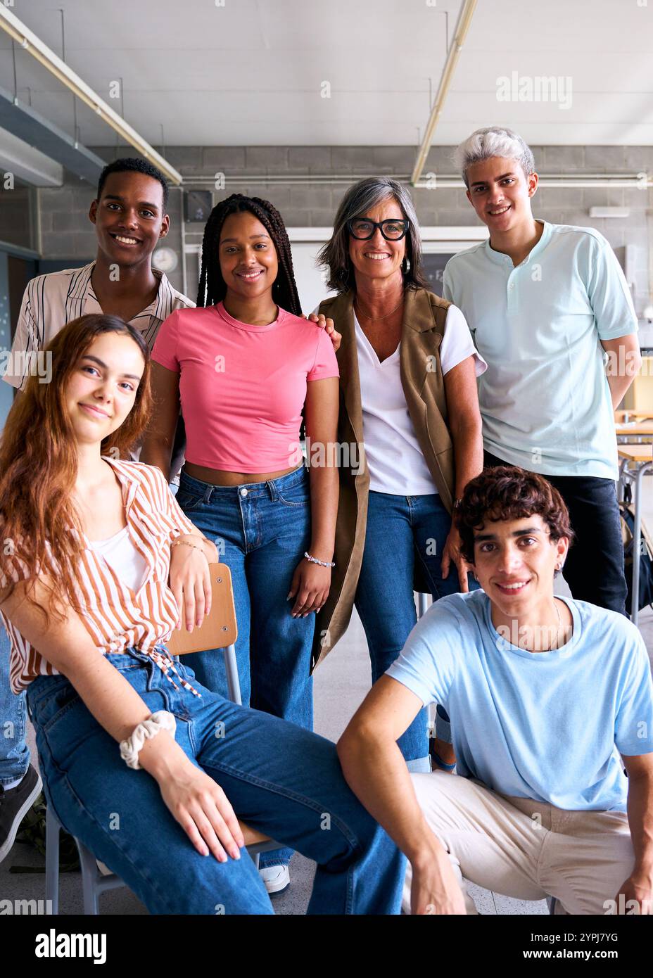 Portrait of happy multiracial group of student posing together in class ...