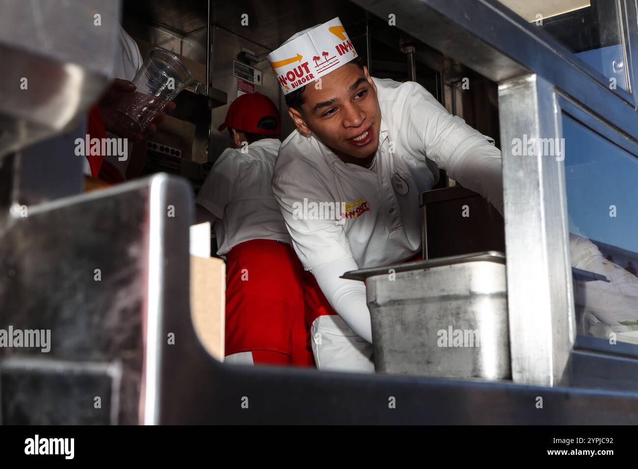 Las Vegas, NV, USA. 30th Nov, 2024. An In-N-Out worker prepares burgers ...