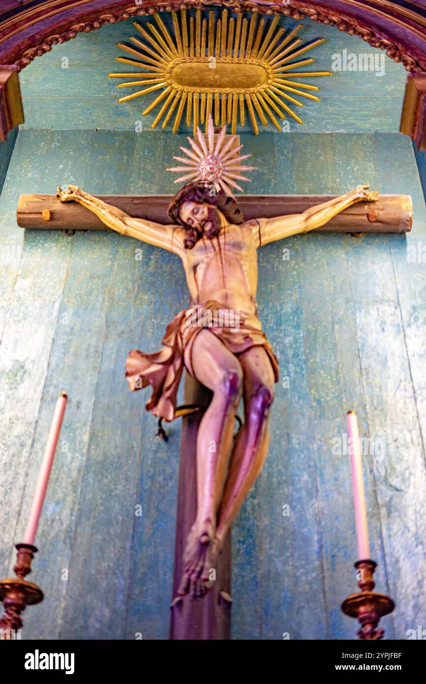 Imposing figure of Jesus Christ crucified on an altar. Religious figure ...