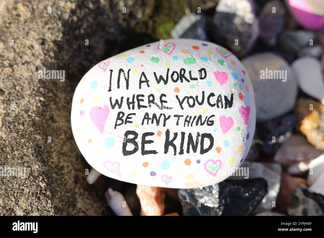Be kind message painted onto white kindness rock Stock Photo - Alamy
