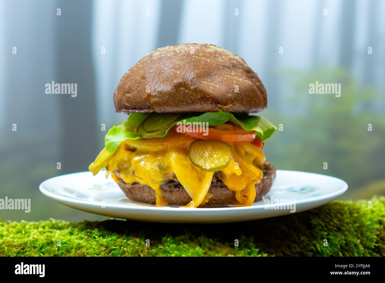 Traditional rustic burger sandwich with cheddar cheese, vegetables and ...