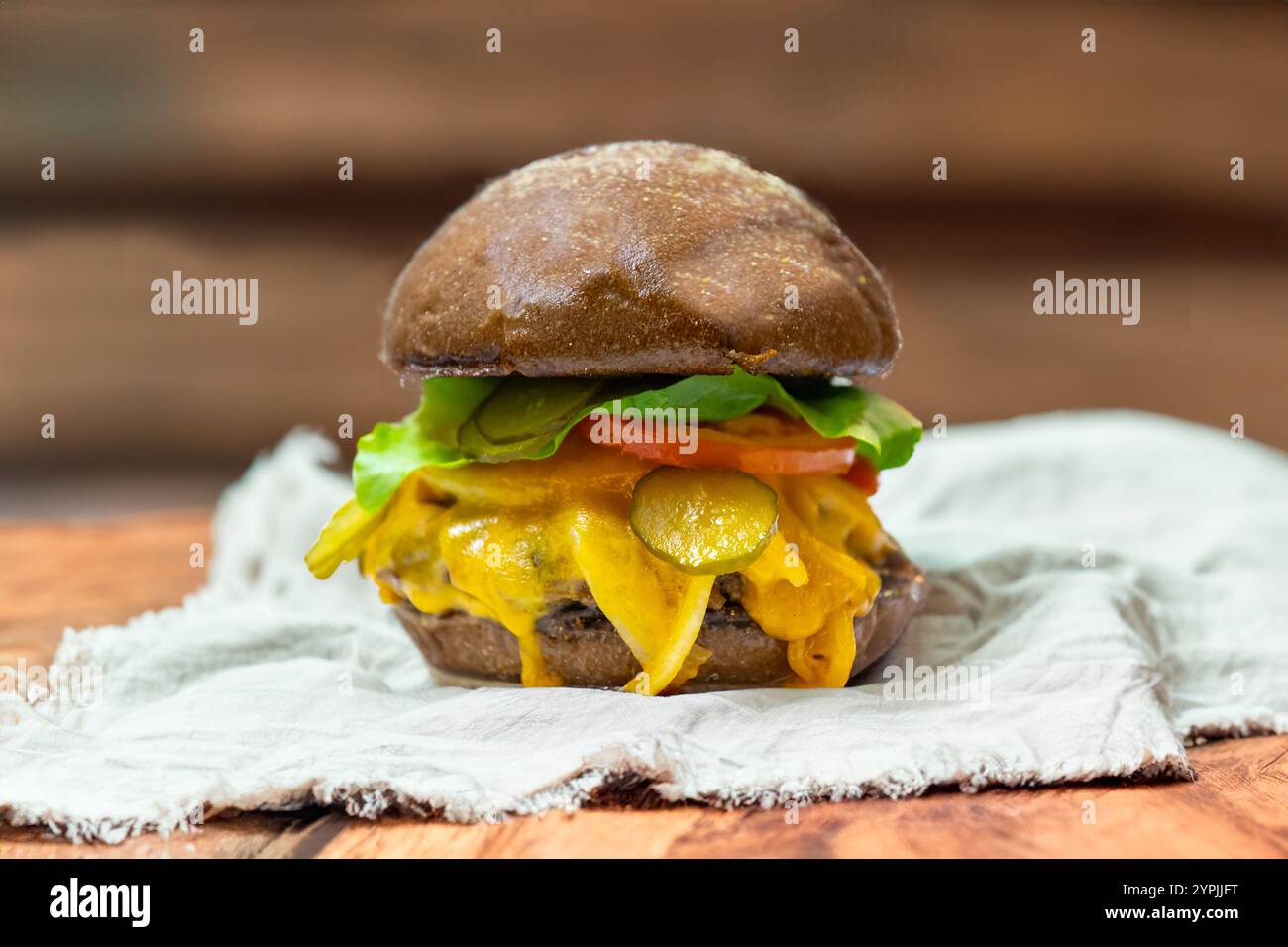 Traditional rustic burger sandwich with cheddar cheese, vegetables and ...