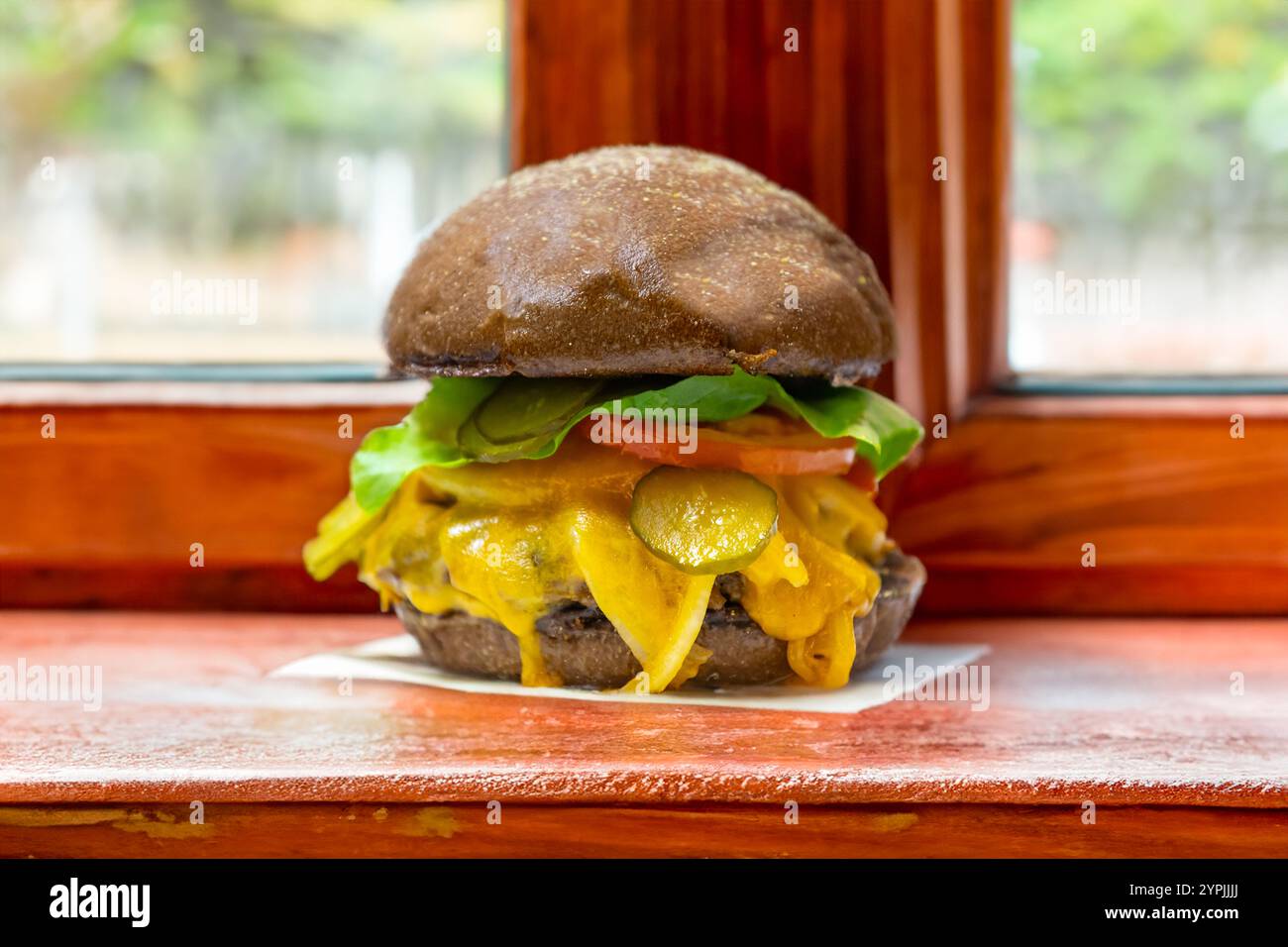 Traditional rustic burger sandwich with cheddar cheese, vegetables and ...