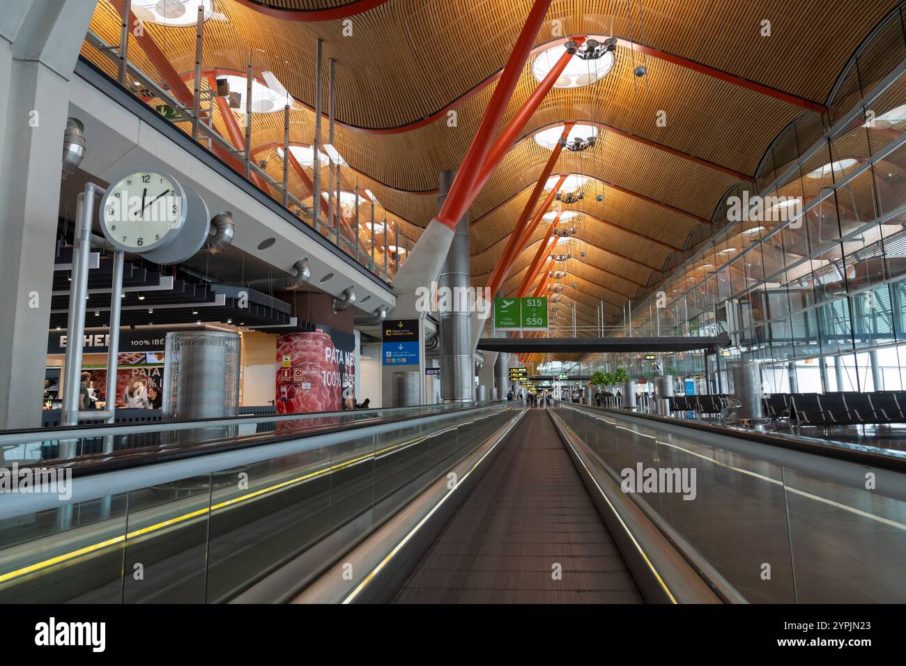 Passengers make their way through Terminal T4s at Madrid-Barajas ...