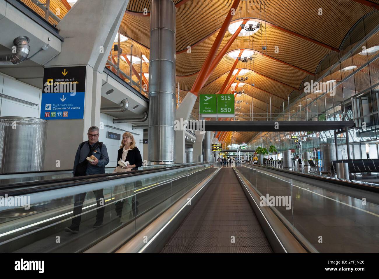 Passengers make their way through Terminal T4s at Madrid-Barajas ...