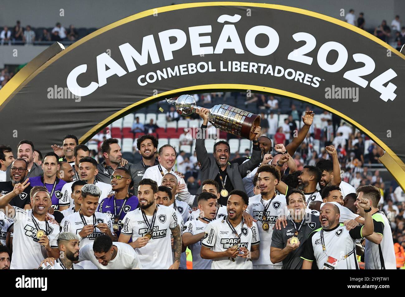 Botafogo's head Portuguese coach Artur Jorge (C) holds up the trophy ...