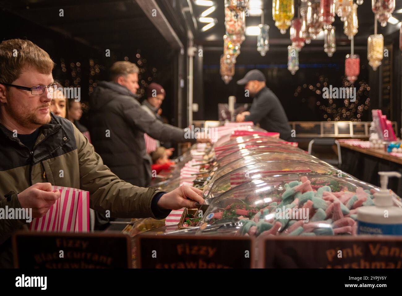 London, UK. 30th Nov, 2024. Shoppers put sweets to their sachets ...
