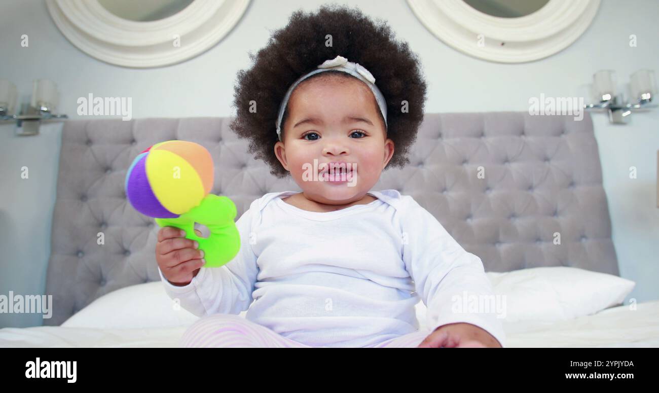 Cute baby playing on bed in high quality Stock Photo - Alamy
