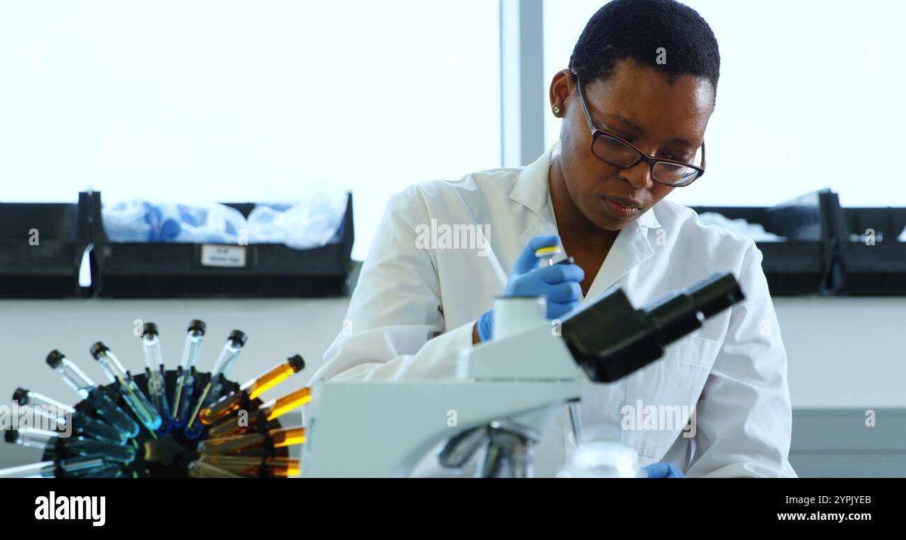 Aettentive female scientist experimenting in laboratory Stock Photo - Alamy