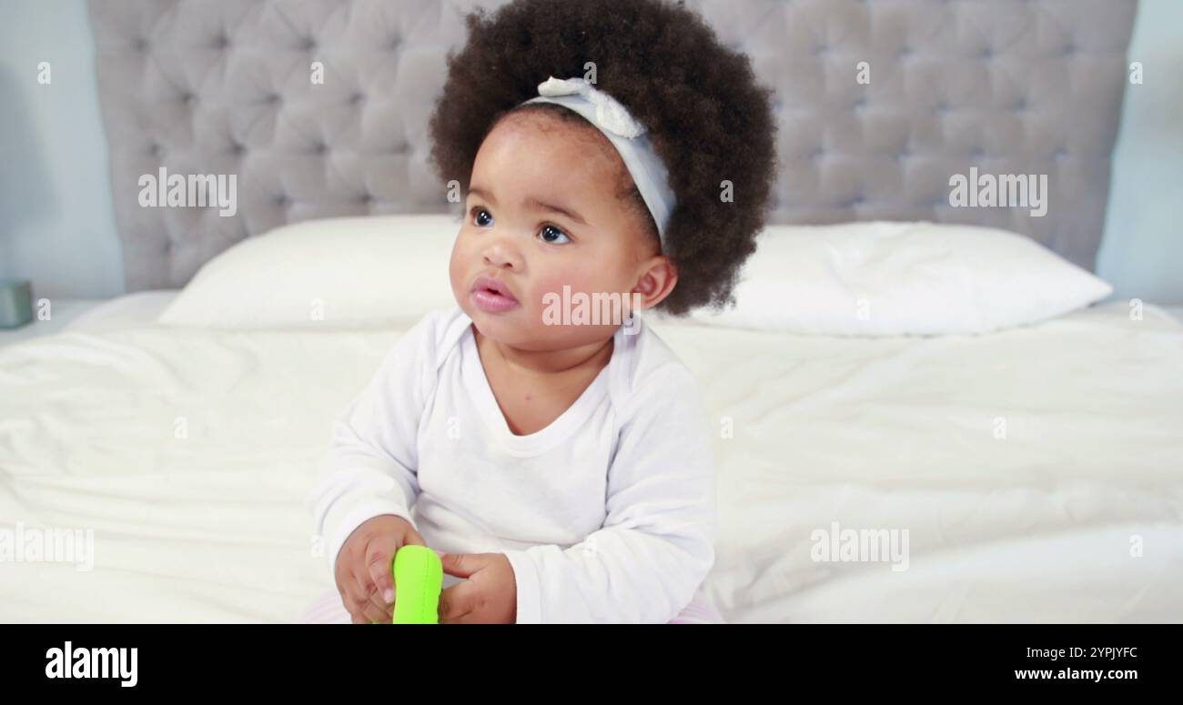Cute baby playing on bed in high quality Stock Photo - Alamy