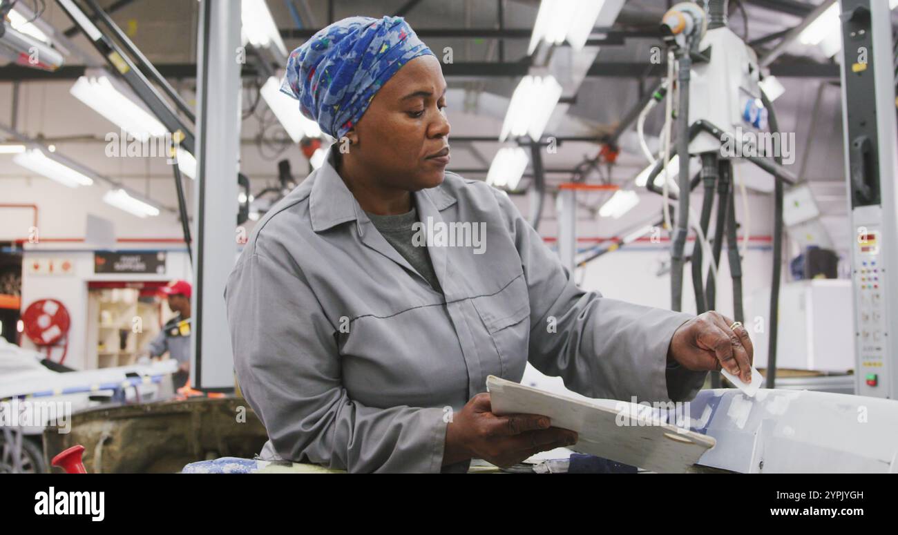 African American female car mechanic working in a township workshop ...