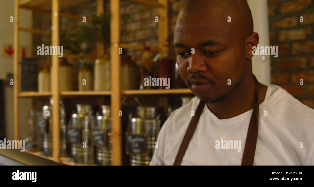 Male staff working on computer at counter Stock Photo - Alamy