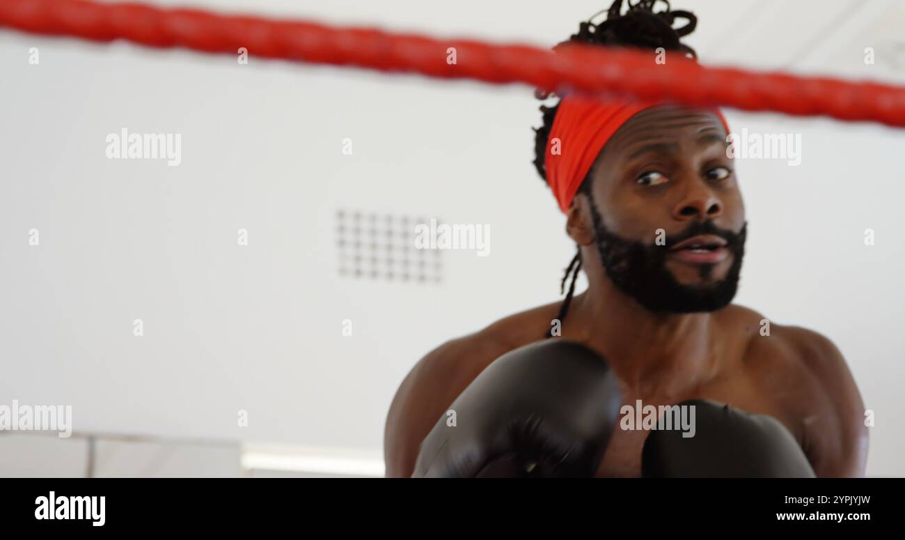 Male boxer practicing boxing in boxing ring at fitness studio Stock ...