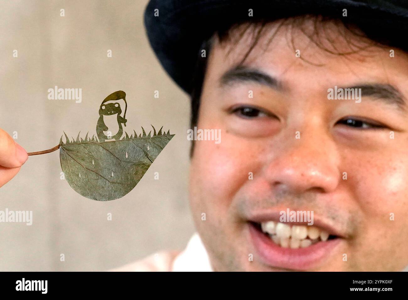 Japanese leaf-cutting artist, who goes by the name Lito, looks at his ...