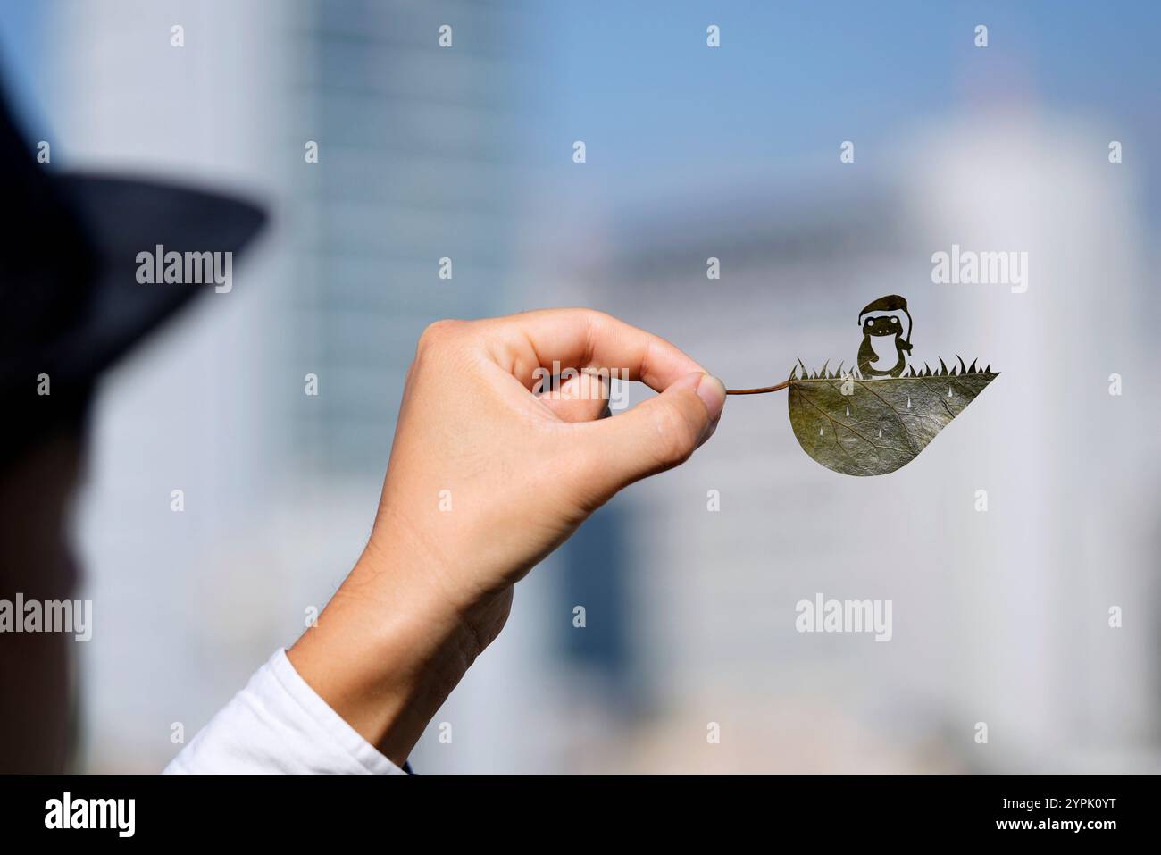 Japanese leaf-cutting artist, who goes by the name Lito, holds up his ...