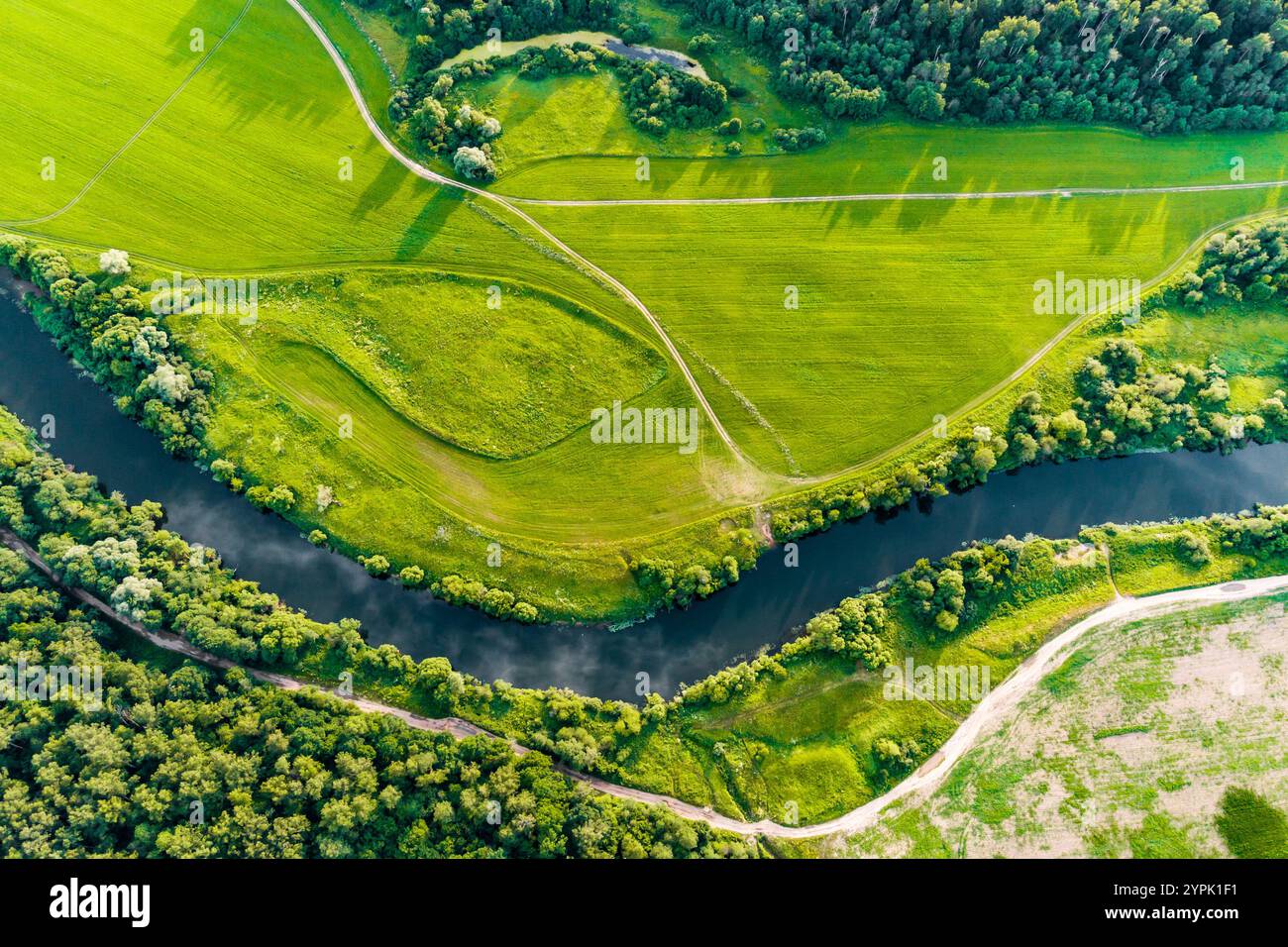 High altitude view of green landscape with river and agricultural ...