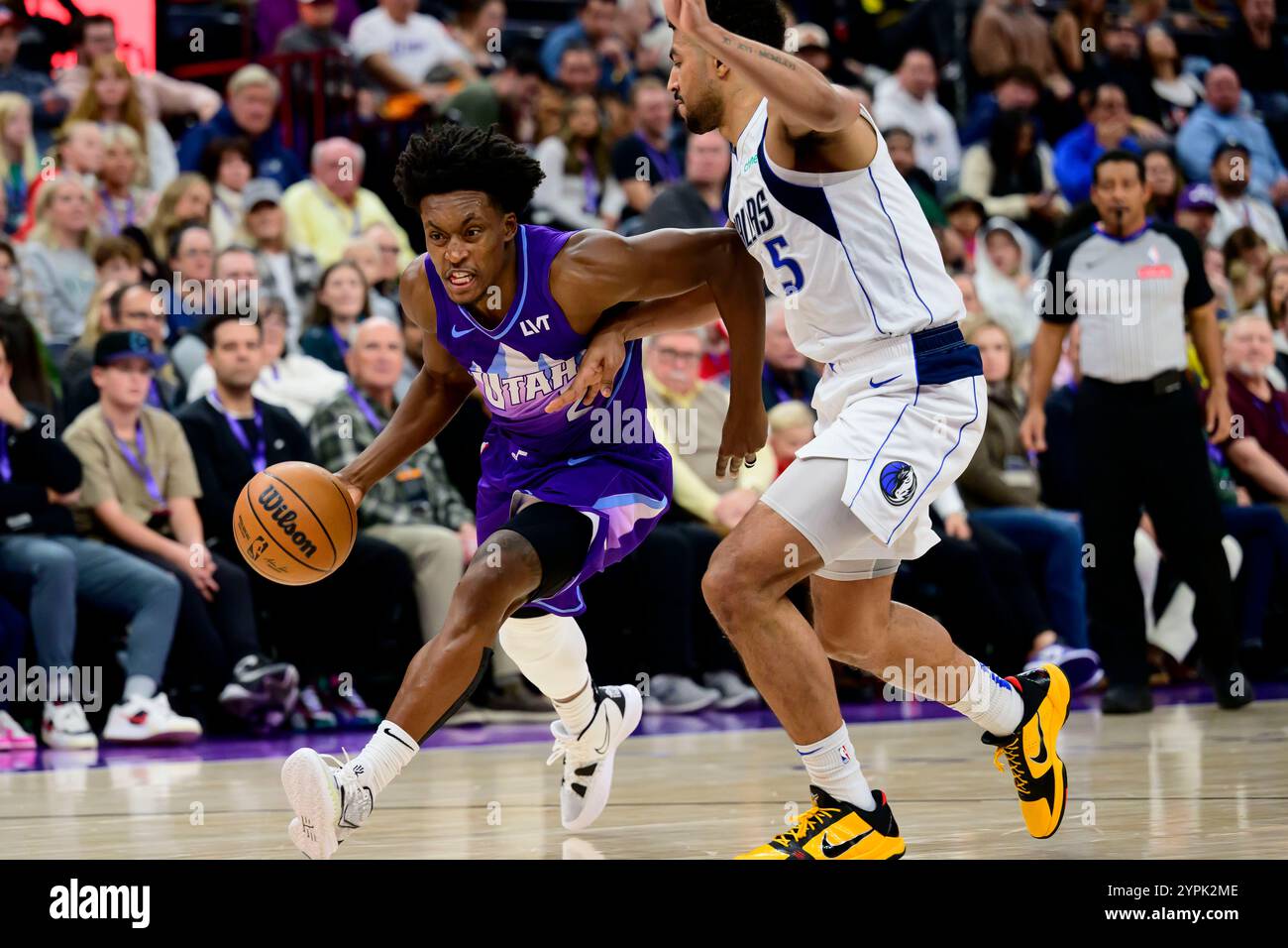 Utah Jazz guard Collin Sexton (center) drives to the basket defended by ...