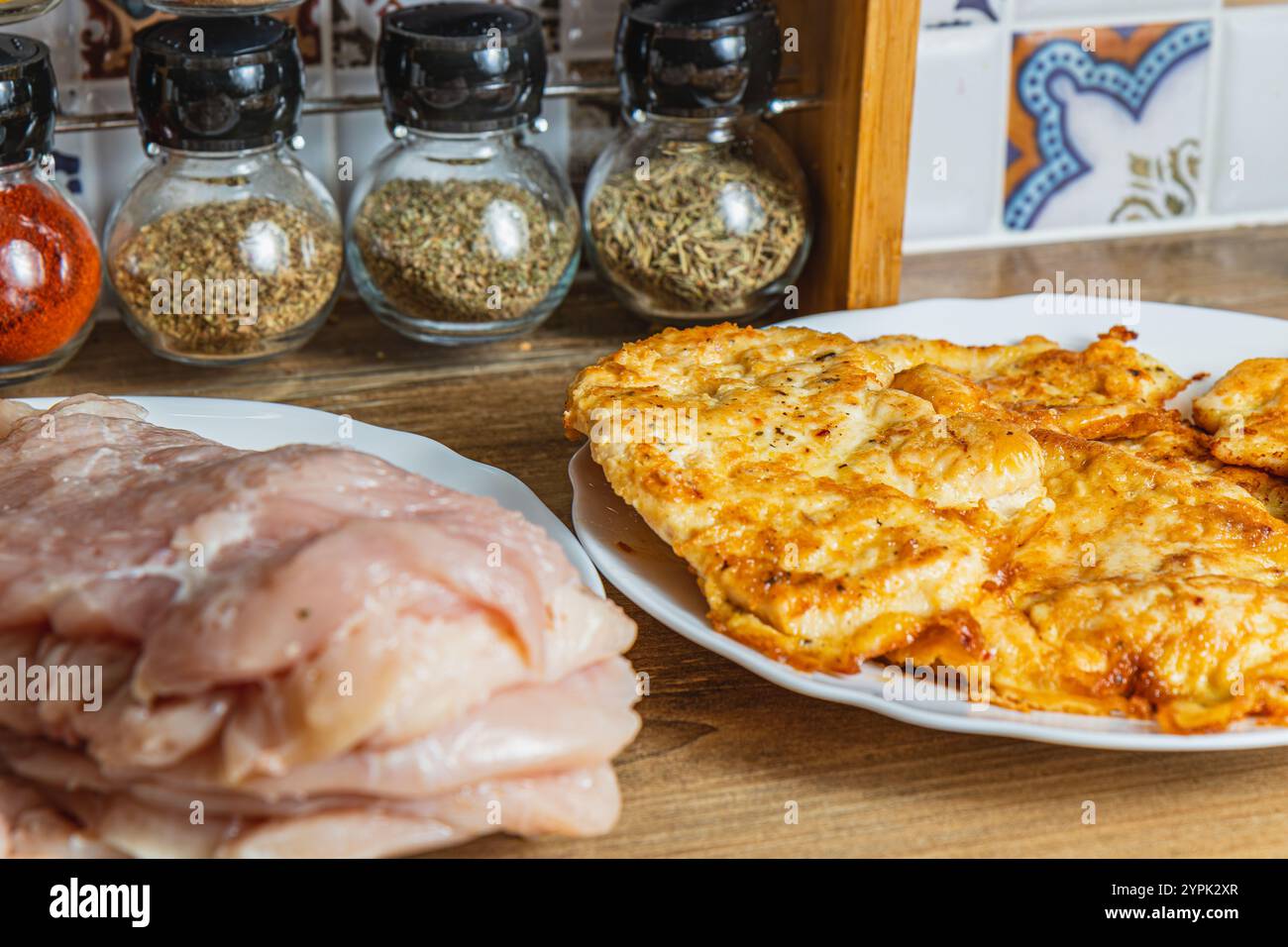 the process of cooking chicken chops with already fried chops in the ...