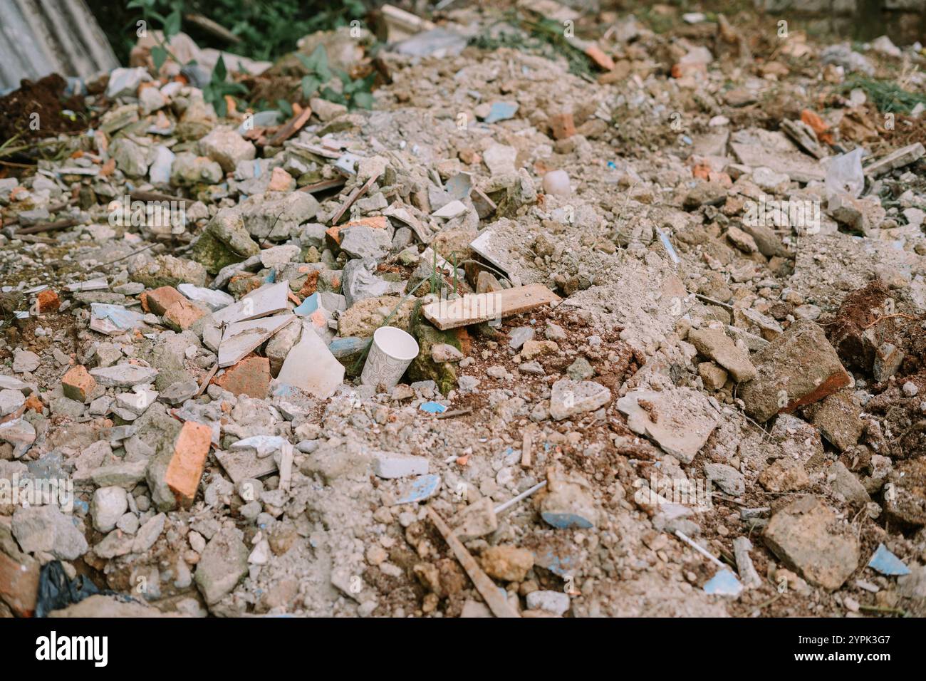 Debris from construction materials discarded in an open field ...