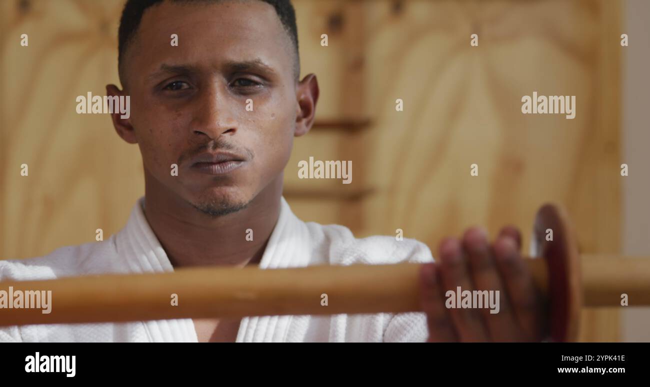Front view of a focused teenage biracial male judoka wearing white ...