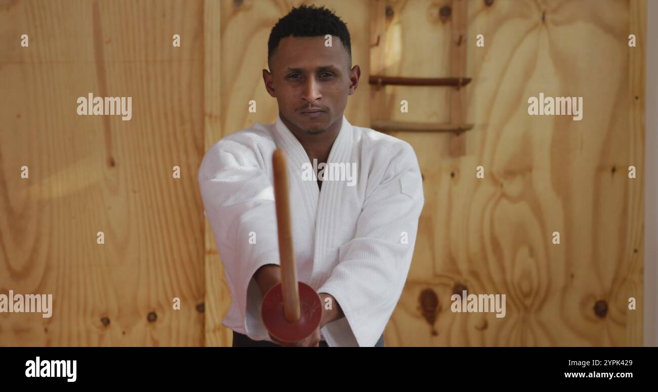 Front view of a focused teenage biracial male judoka wearing white ...