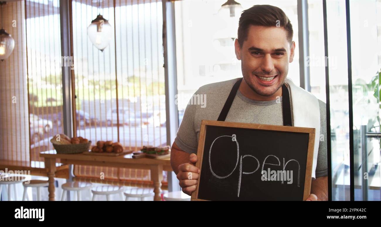 Portrait of Smiling waiter with chalkboard in cafe Stock Photo - Alamy