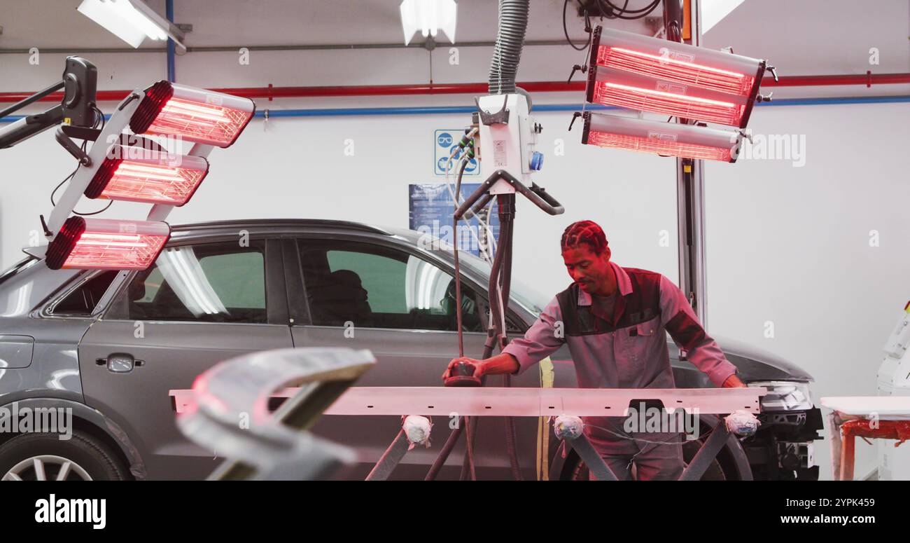 African American male car mechanic working in a township workshop ...