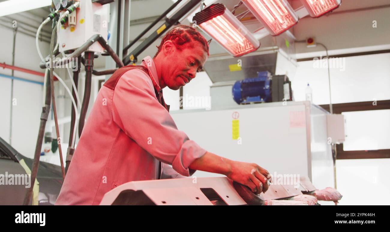 African American male car mechanic working in a township workshop ...