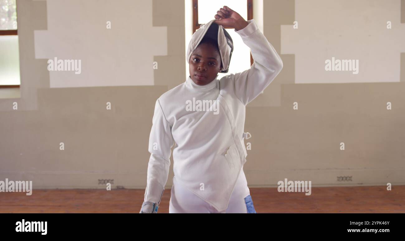 Portrait of a happy biracial female fencer athlete during a fencing ...