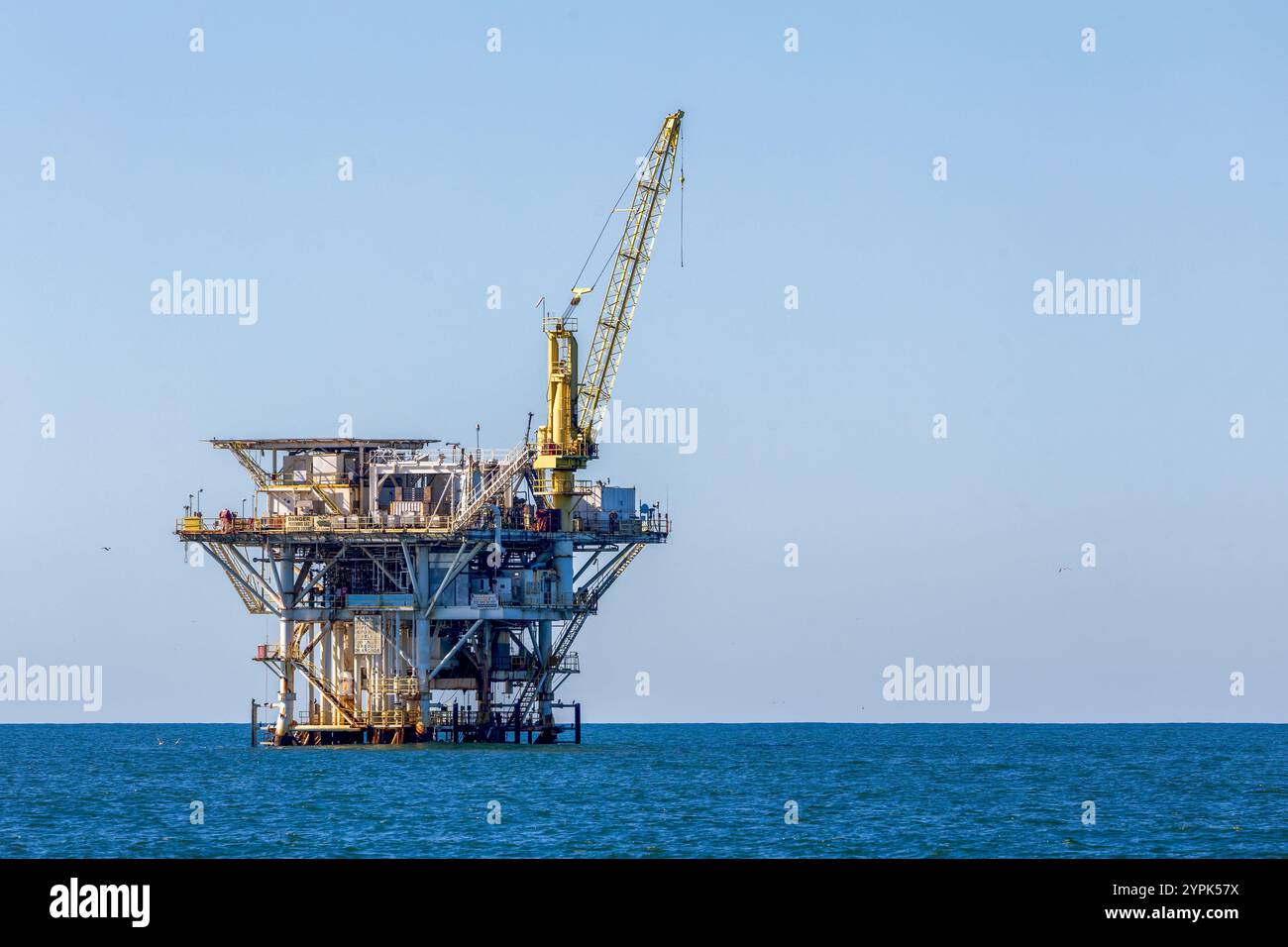 Old abandoned sea rusty drilling platform in the ocean near Channel ...