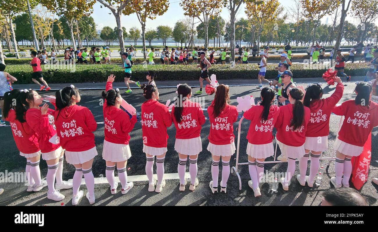 SHANGHAI, CHINA - DECEMBER 1, 2024 - Citizens and cheerleaders cheer on ...