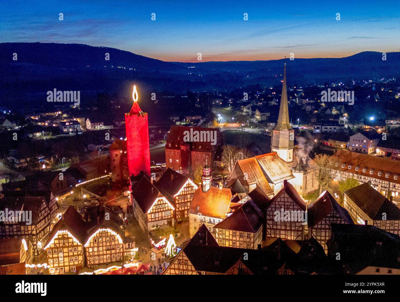 A 42-meter-high candle which is an illuminated medieval tower shines in ...