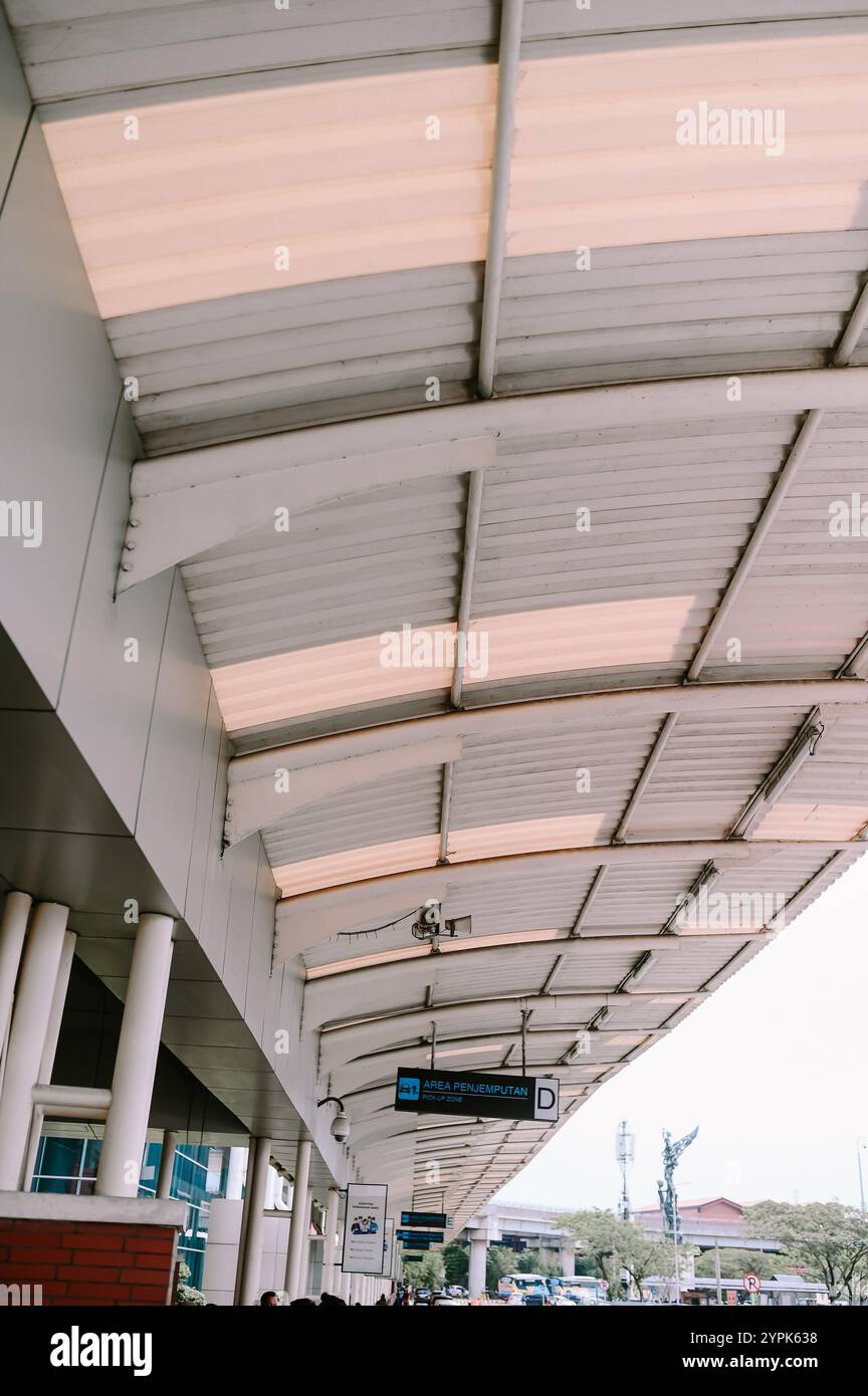 A canopy providing shelter from heat and rain at an airport pickup area ...
