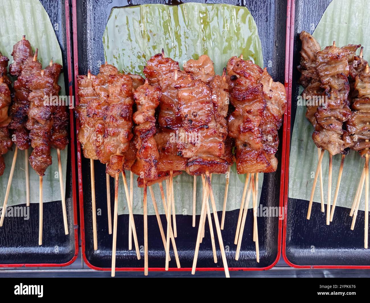 An arrangement of grilled pork satay or moo ping in Thailand. Moo ping ...