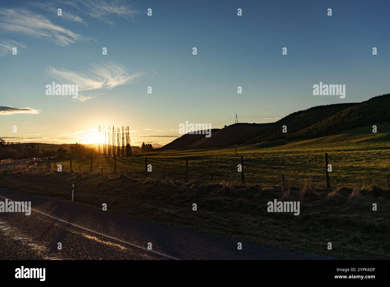 A stunning sunset casts beautiful colors over the rolling hills and ...