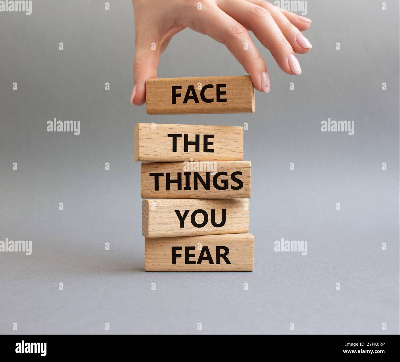 Face the things you fear symbol. Wooden blocks with words Face the ...
