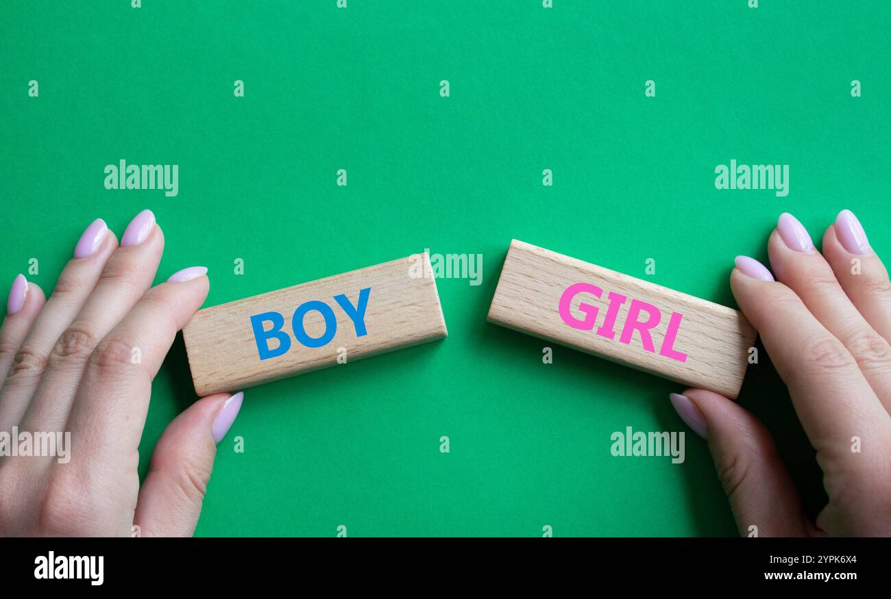 Boy or Girl symbol. Concept word Boy or Girl on wooden blocks. Man hand ...