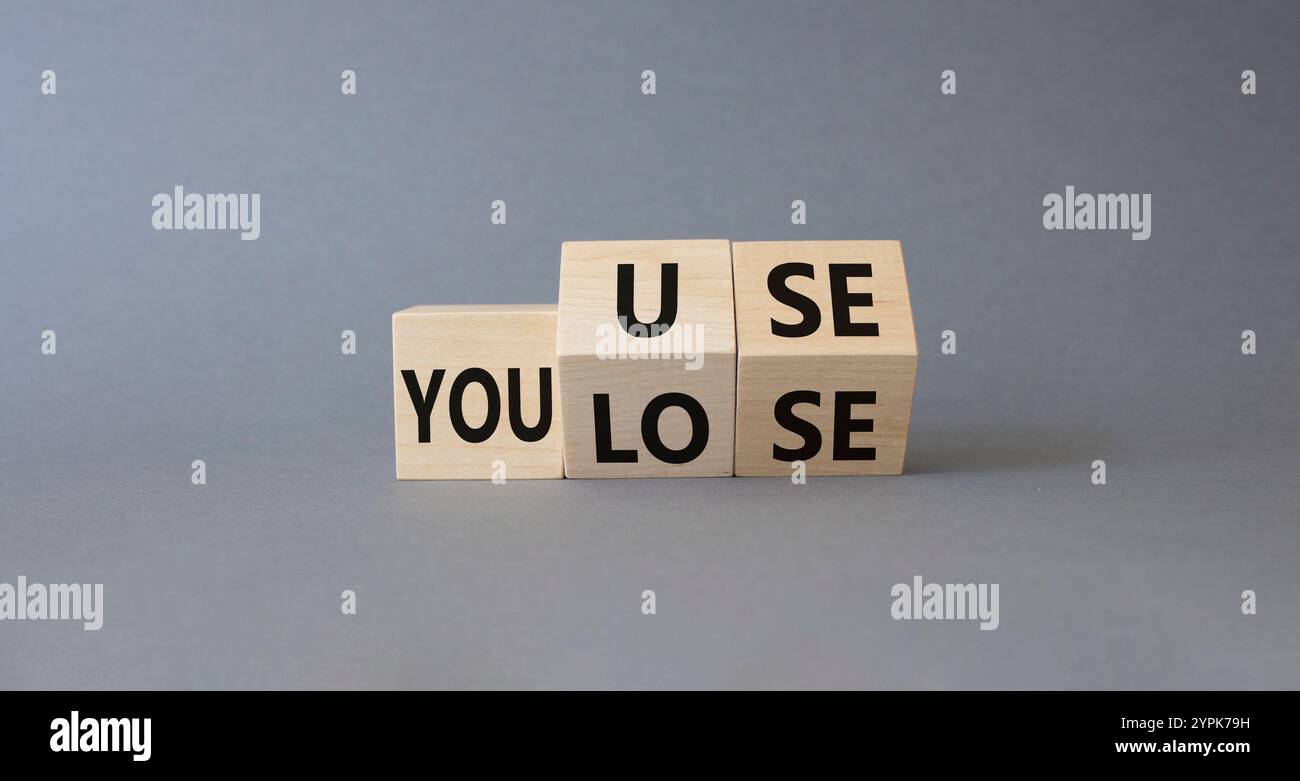 You use or lose symbol. Turned wooden cubes with words You lose or You ...
