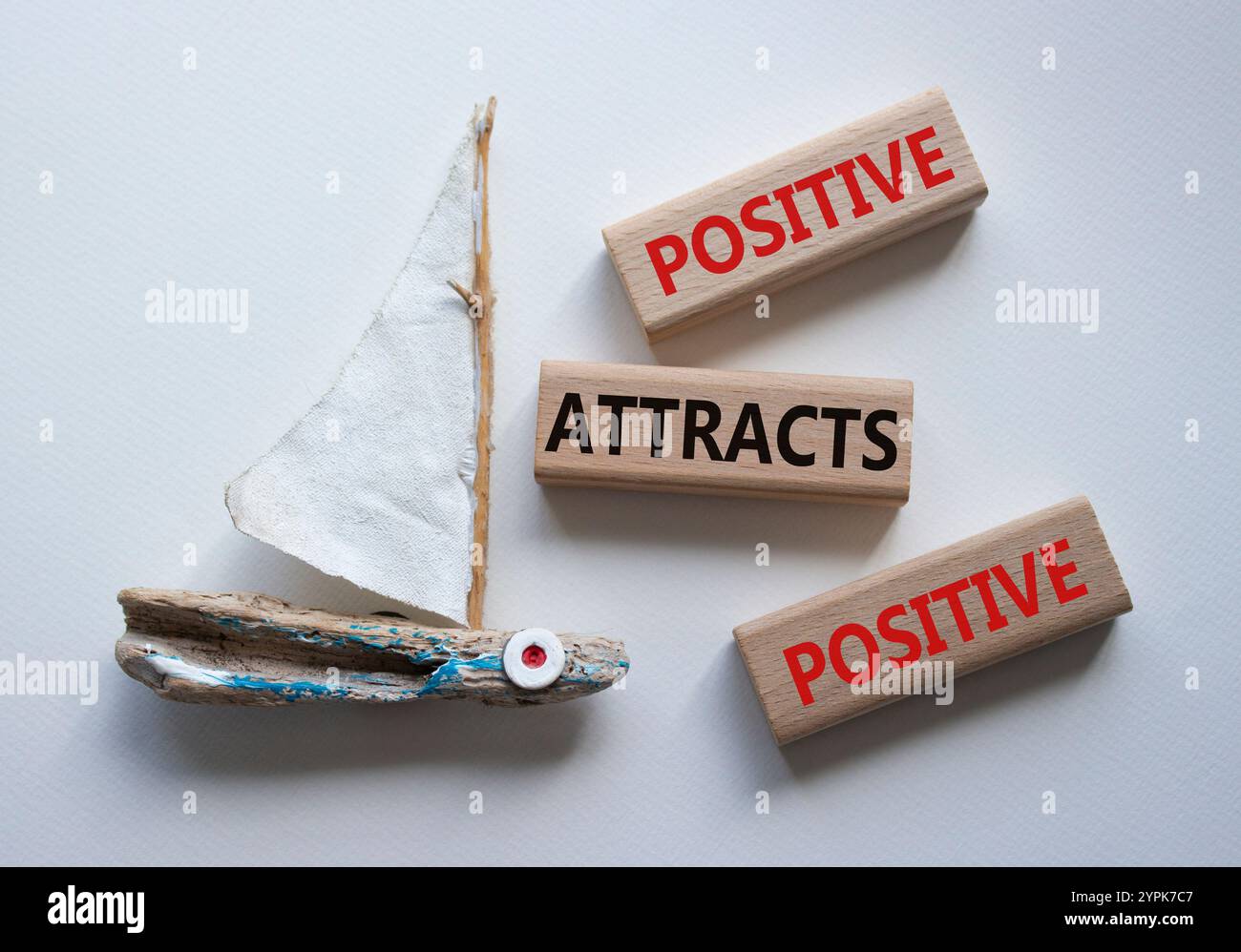 Positive attracts Positive symbol. Wooden blocks with words Positive ...