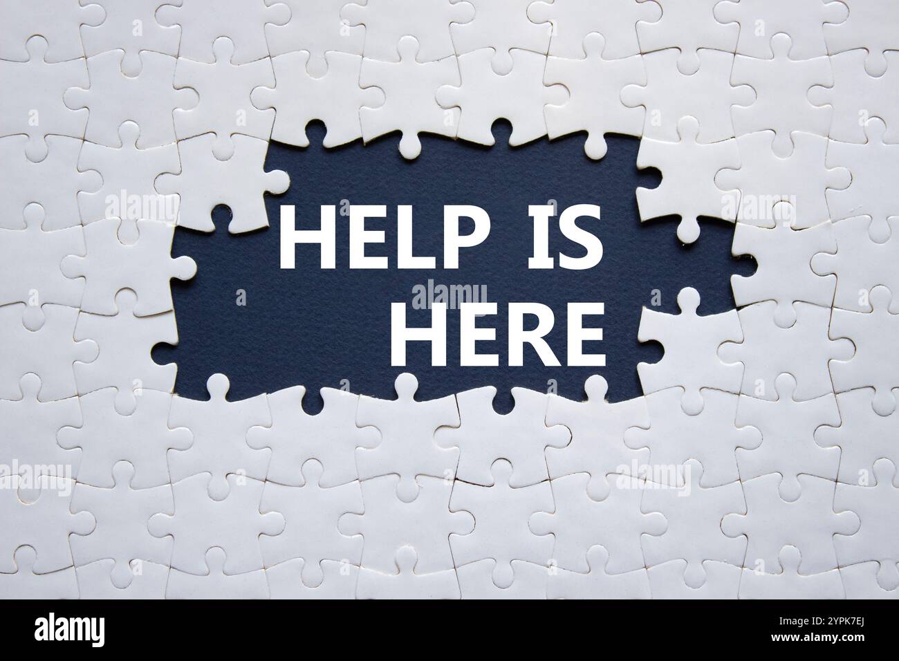 Help is here symbol. Concept words Help is here on white puzzle ...