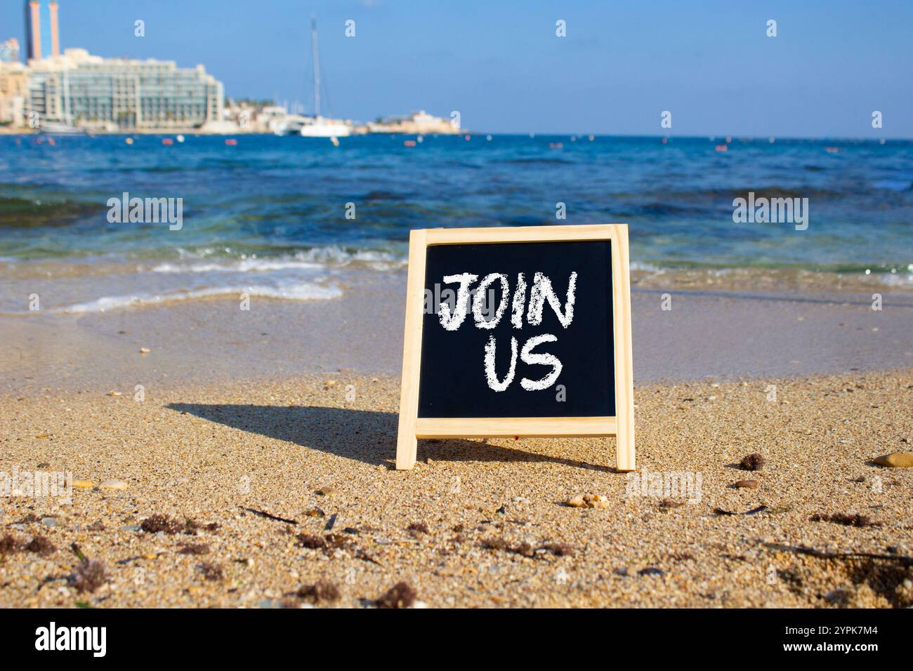 Join us symbol. Concept word Join us on black chalk background. Beautiful sea background ...