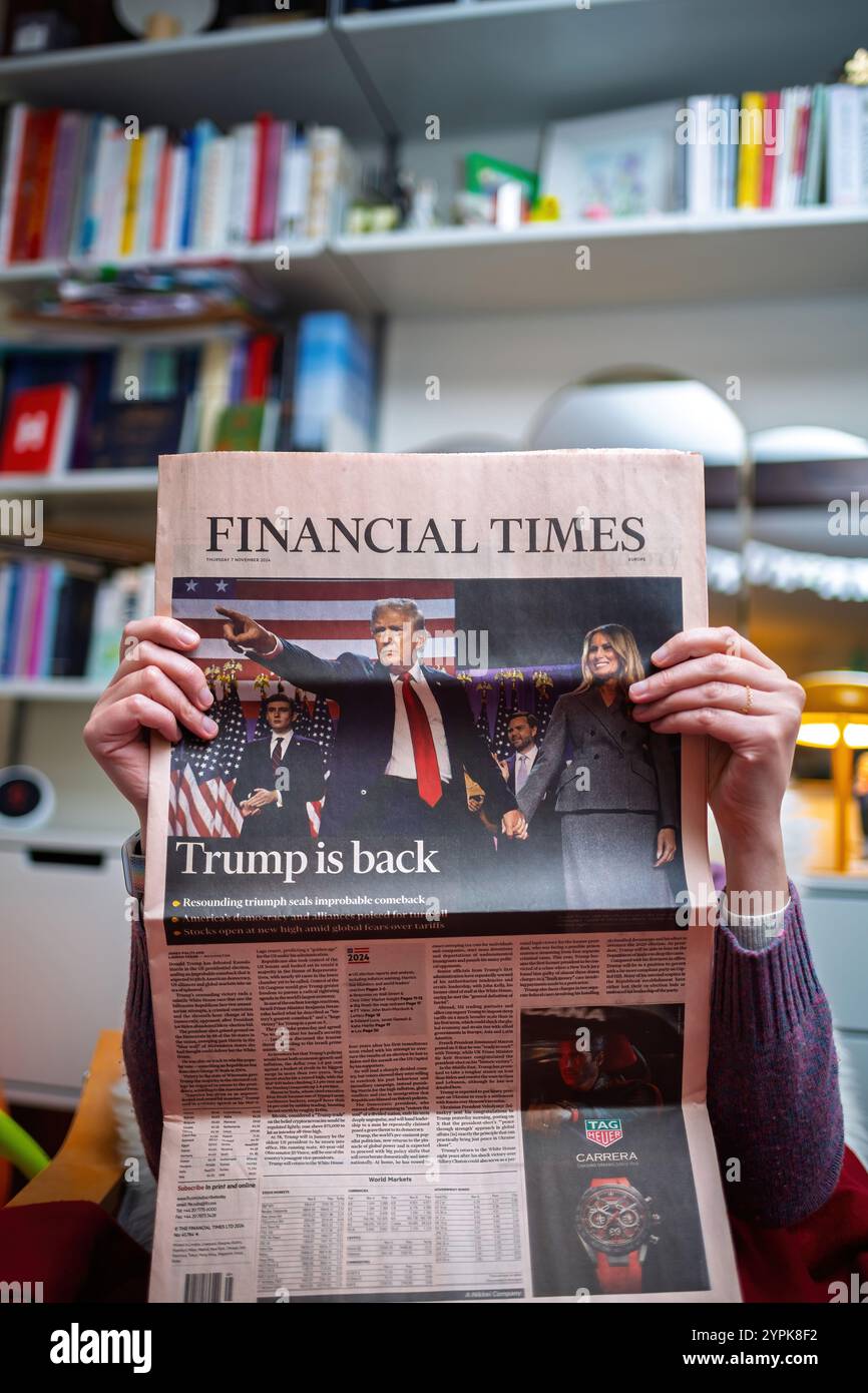 Paris, France - Nov 13, 2024: A woman holds up the Financial Times ...